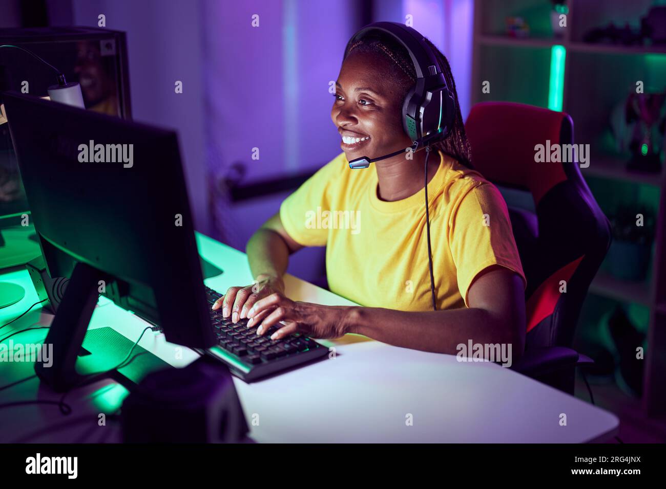 African american woman streamer playing video game using computer at ...