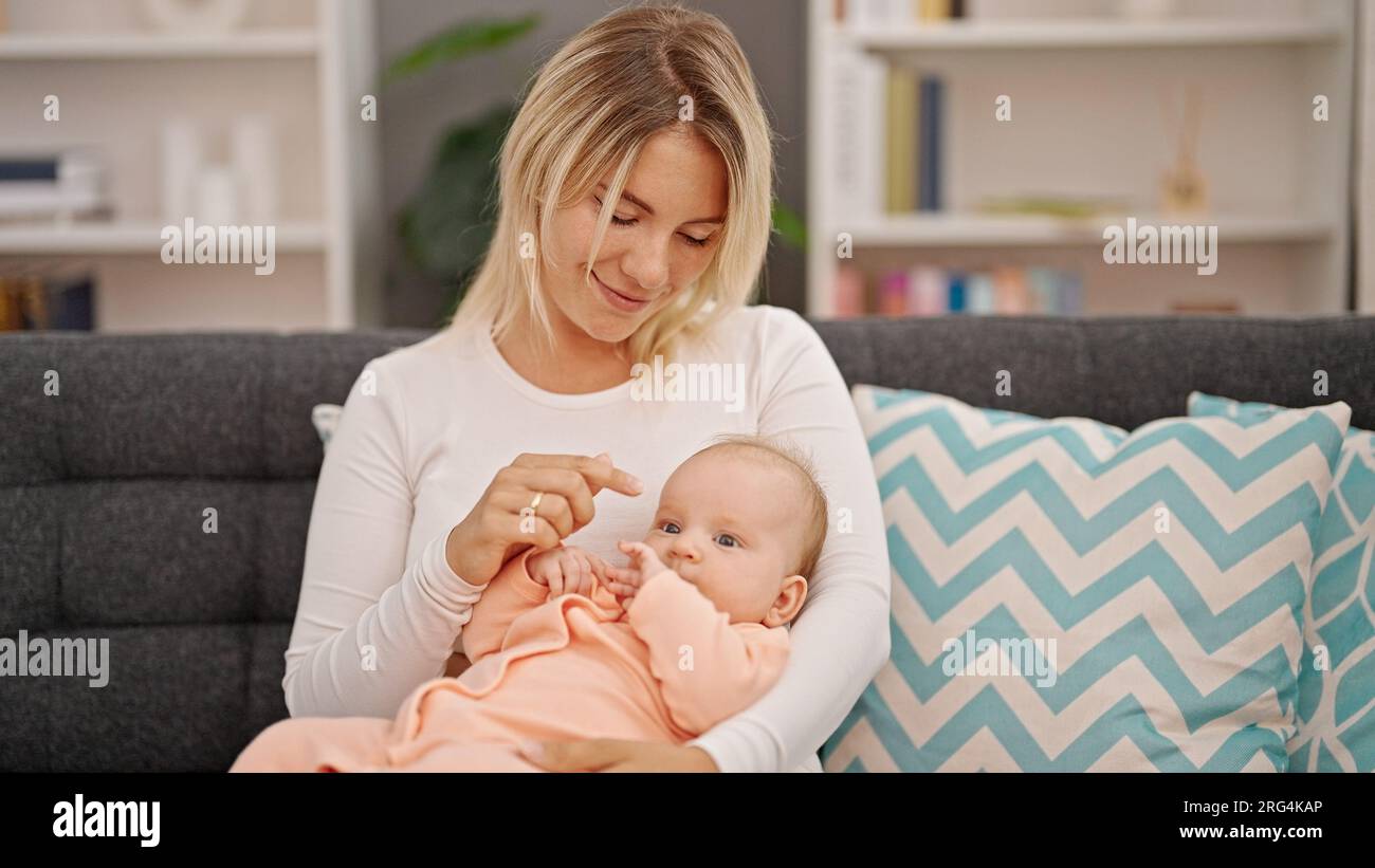 Mother and daughter hugging each other at home Stock Photo - Alamy