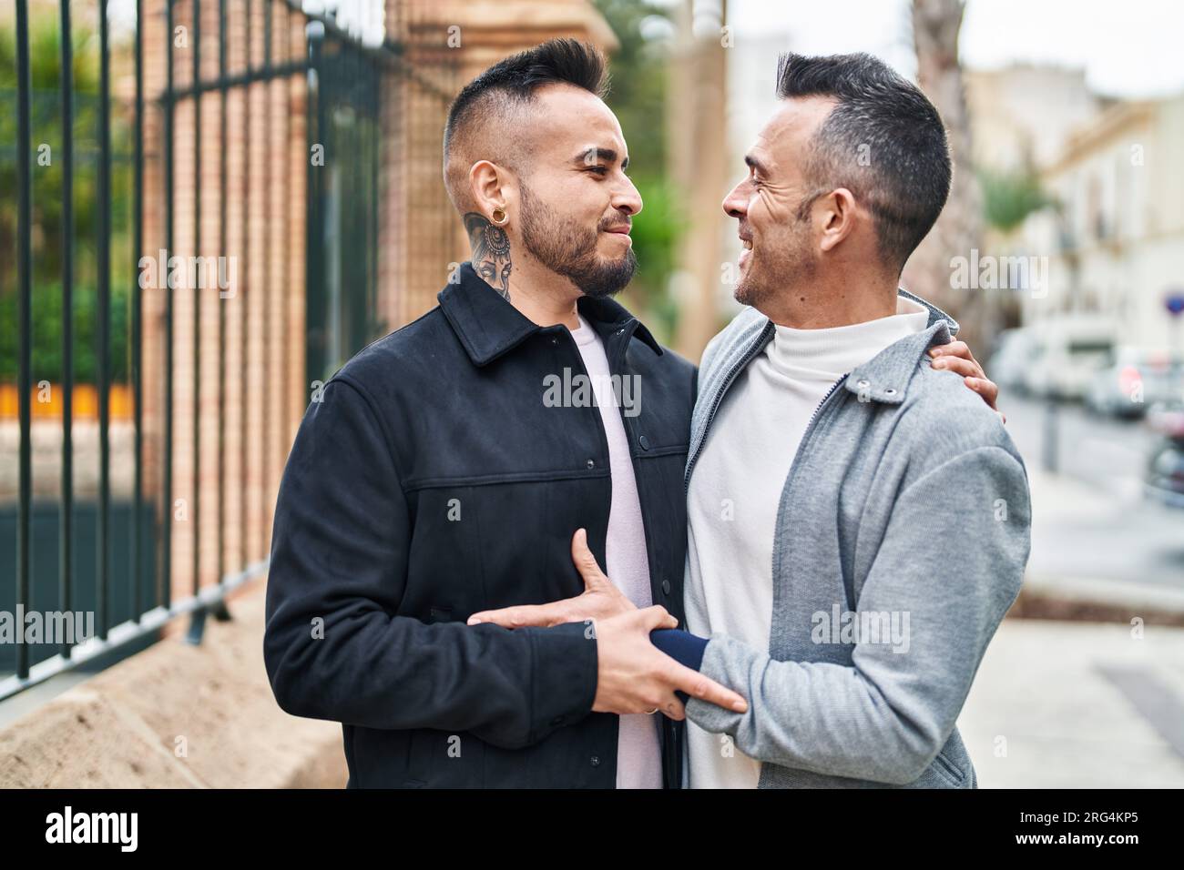 Two men couple smiling confident hugging each other at street Stock ...