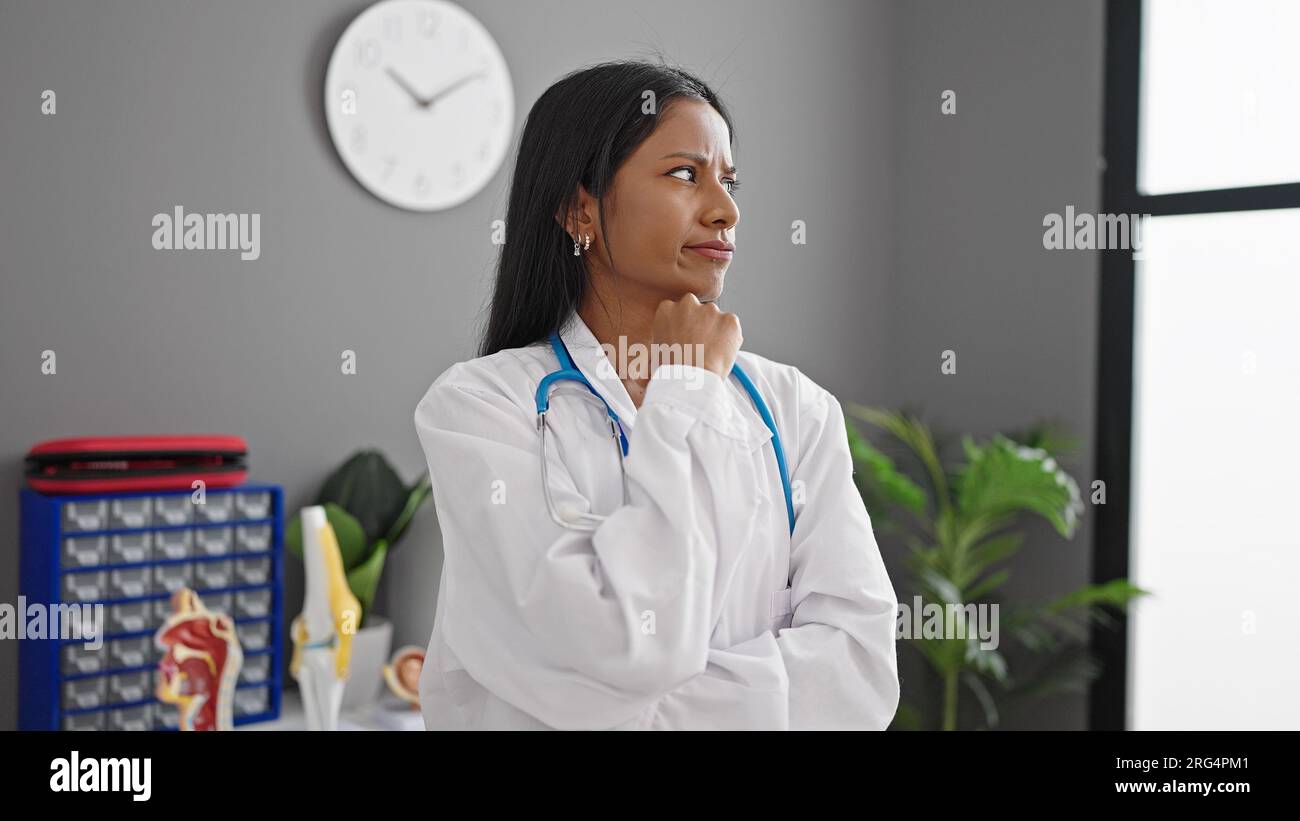 African american woman doctor standing with doubt expression thinking ...