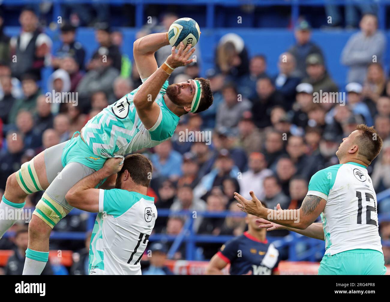 South Africa's Springbooks Jean Kleyn (L) catches the ball helped by ...
