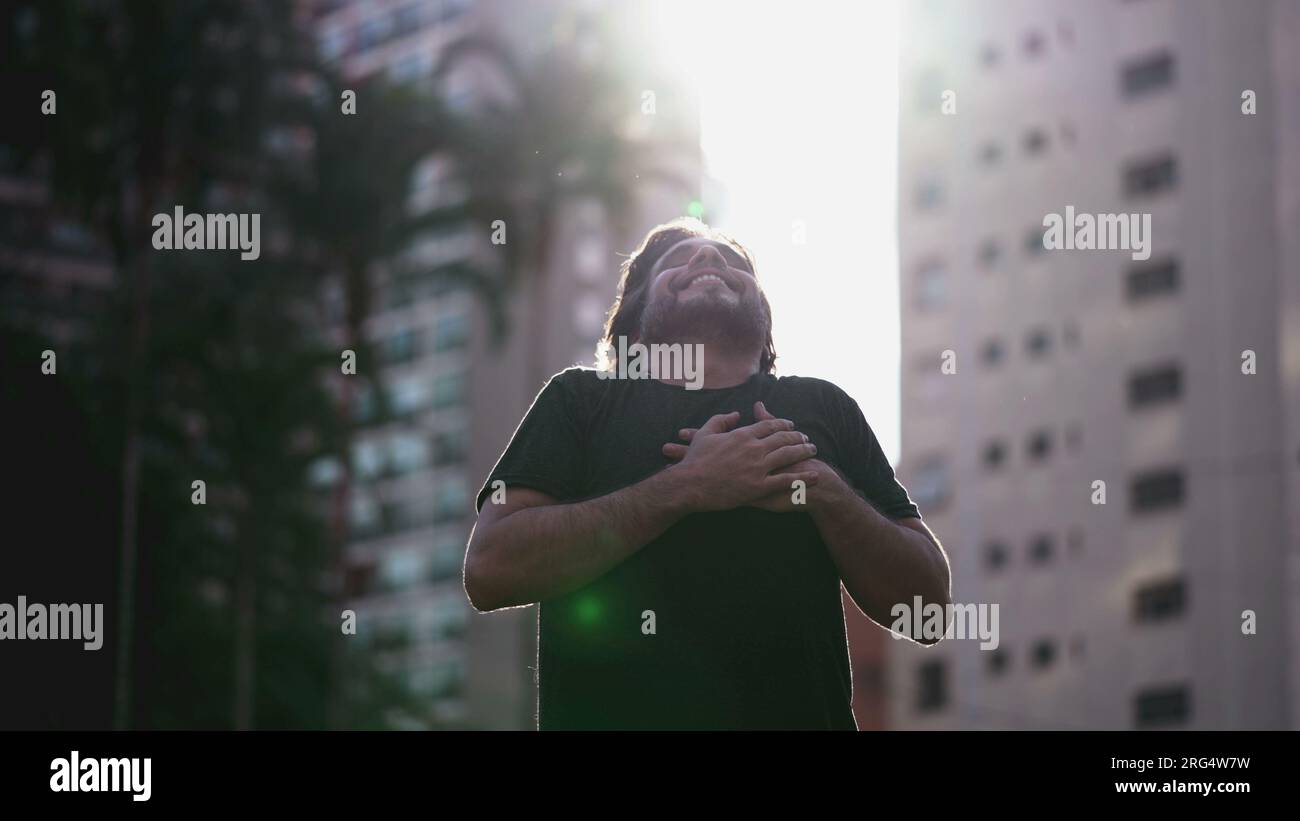 One young Religious Man looking up at the sky with HOPE and FAITH. A ...