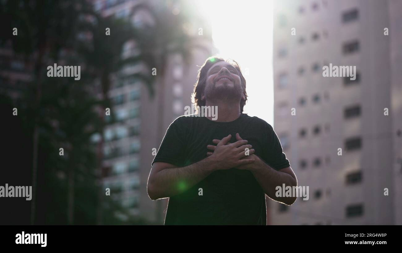 One young Religious Man looking up at the sky with HOPE and FAITH. A ...