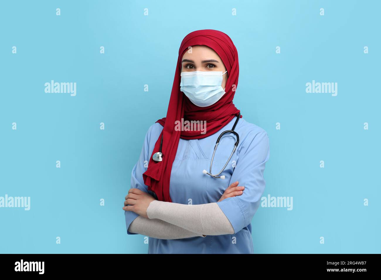 Muslim woman wearing hijab, medical uniform and protective mask on ...
