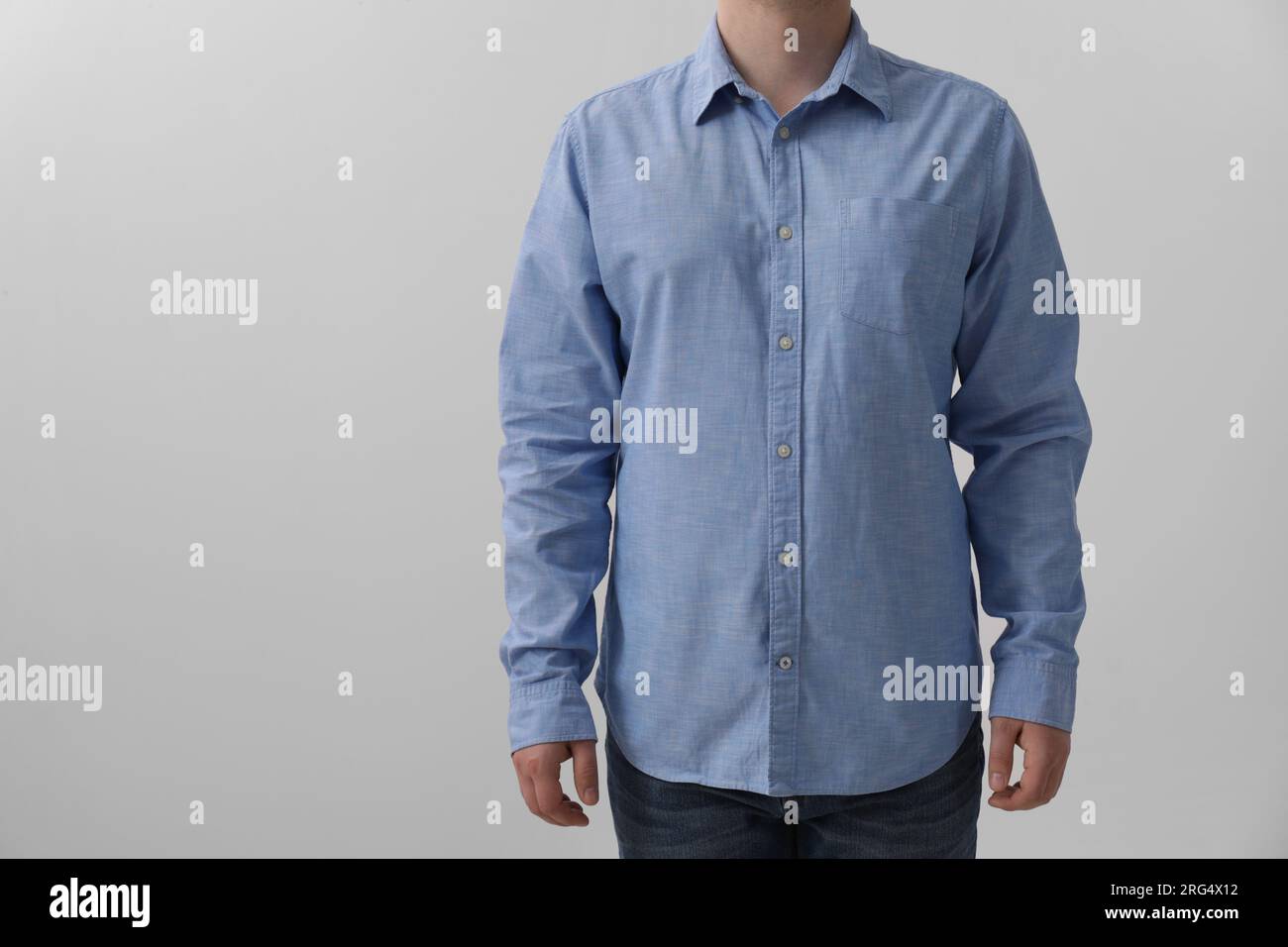 Man wearing light blue shirt on white background, closeup Stock Photo ...