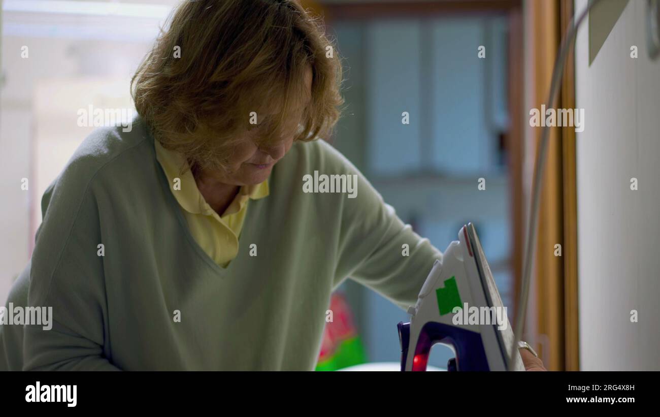 Ironing Out Domestic Chores Candid Footage of Senior Woman in Laundry ...