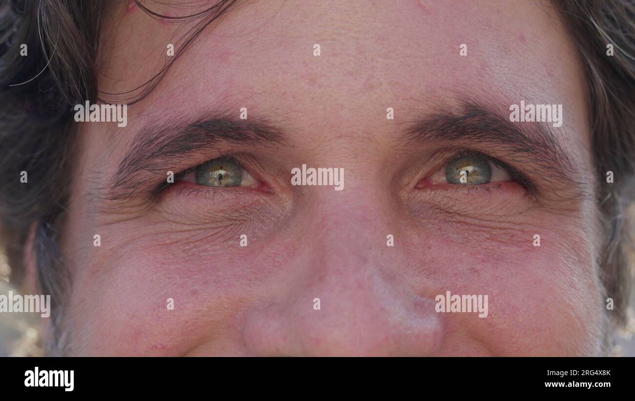 Happy man with surprise reaction smiling directly at camera in macro ...