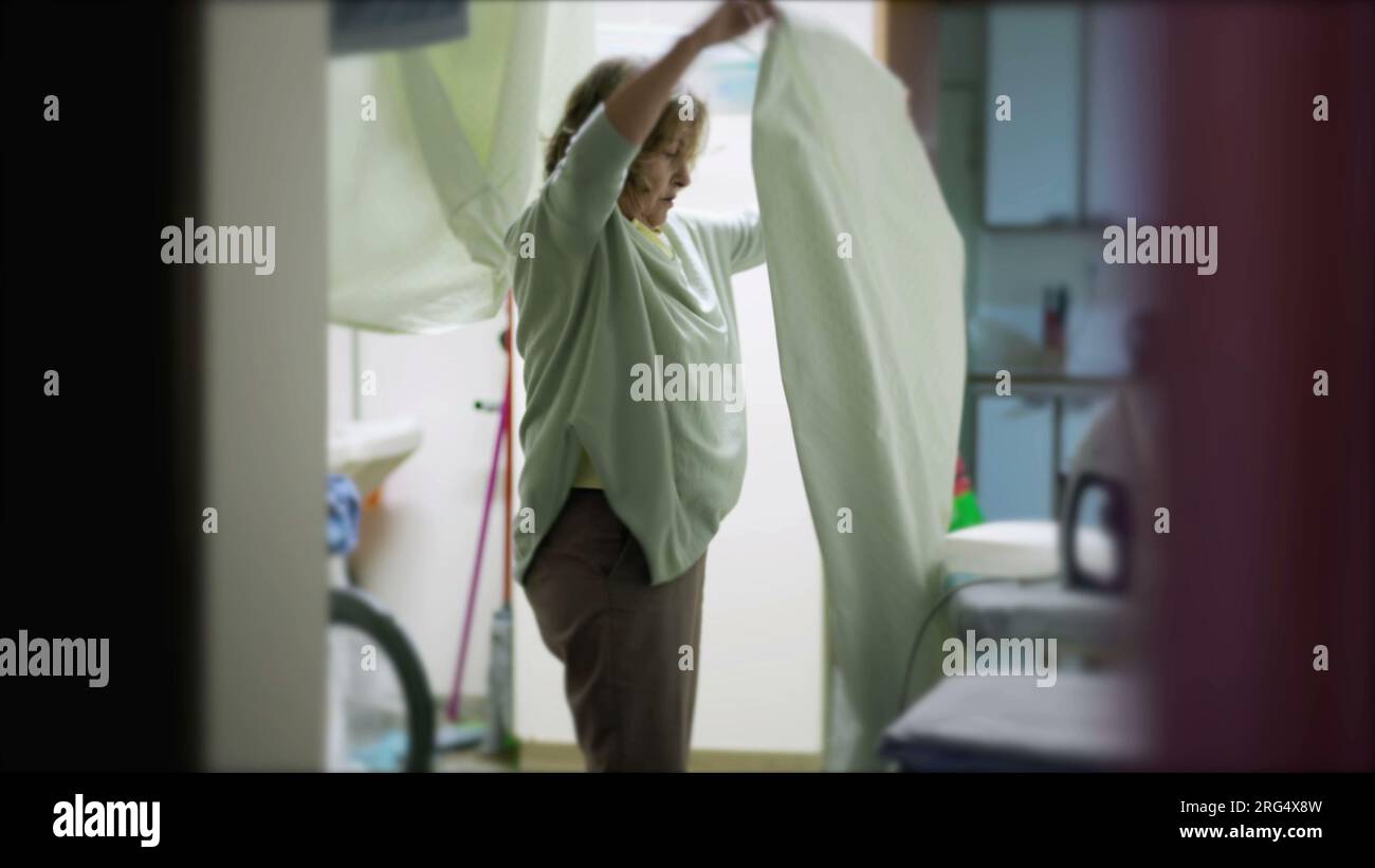 Efficient and Independent Senior Lady Tackles Household Chores in Her ...