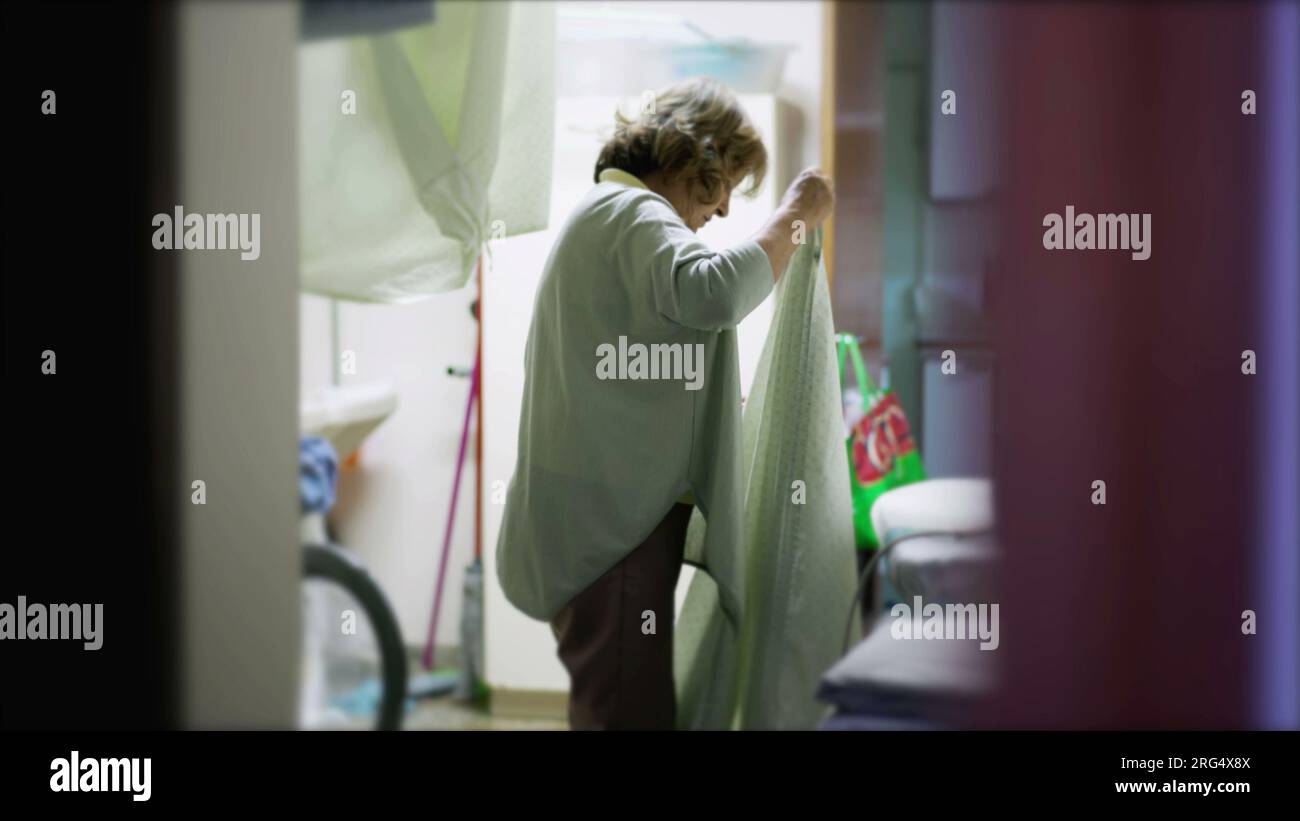Efficient and Independent Senior Lady Tackles Household Chores in Her ...