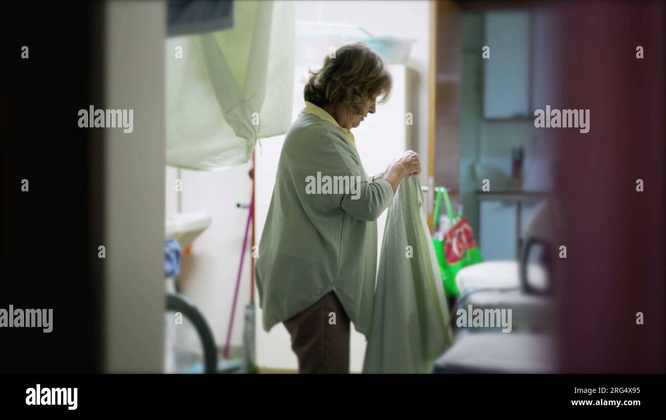 Efficient and Independent Senior Lady Tackles Household Chores in Her ...