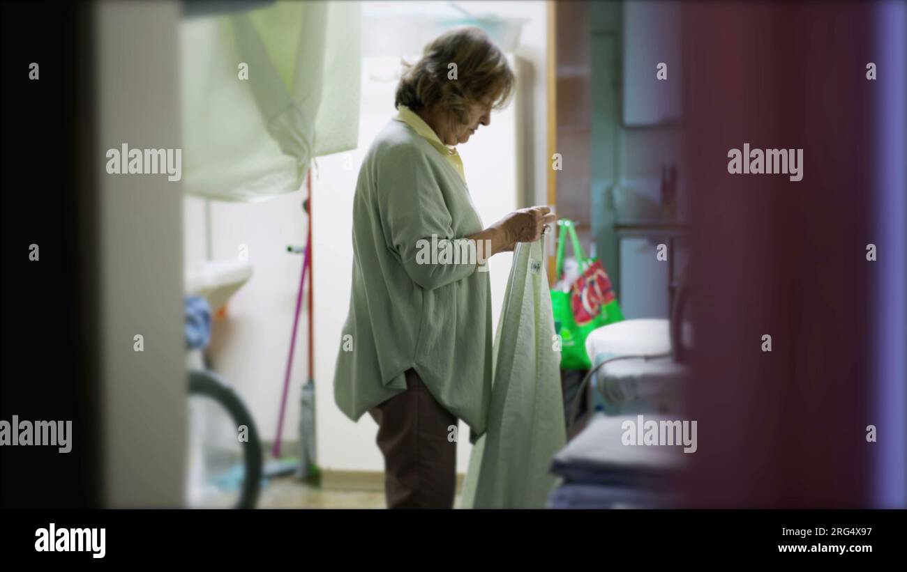 Efficient and Independent Senior Lady Tackles Household Chores in Her ...