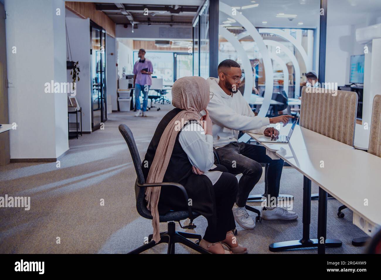 In a modern office setting, an African American businessman and his ...