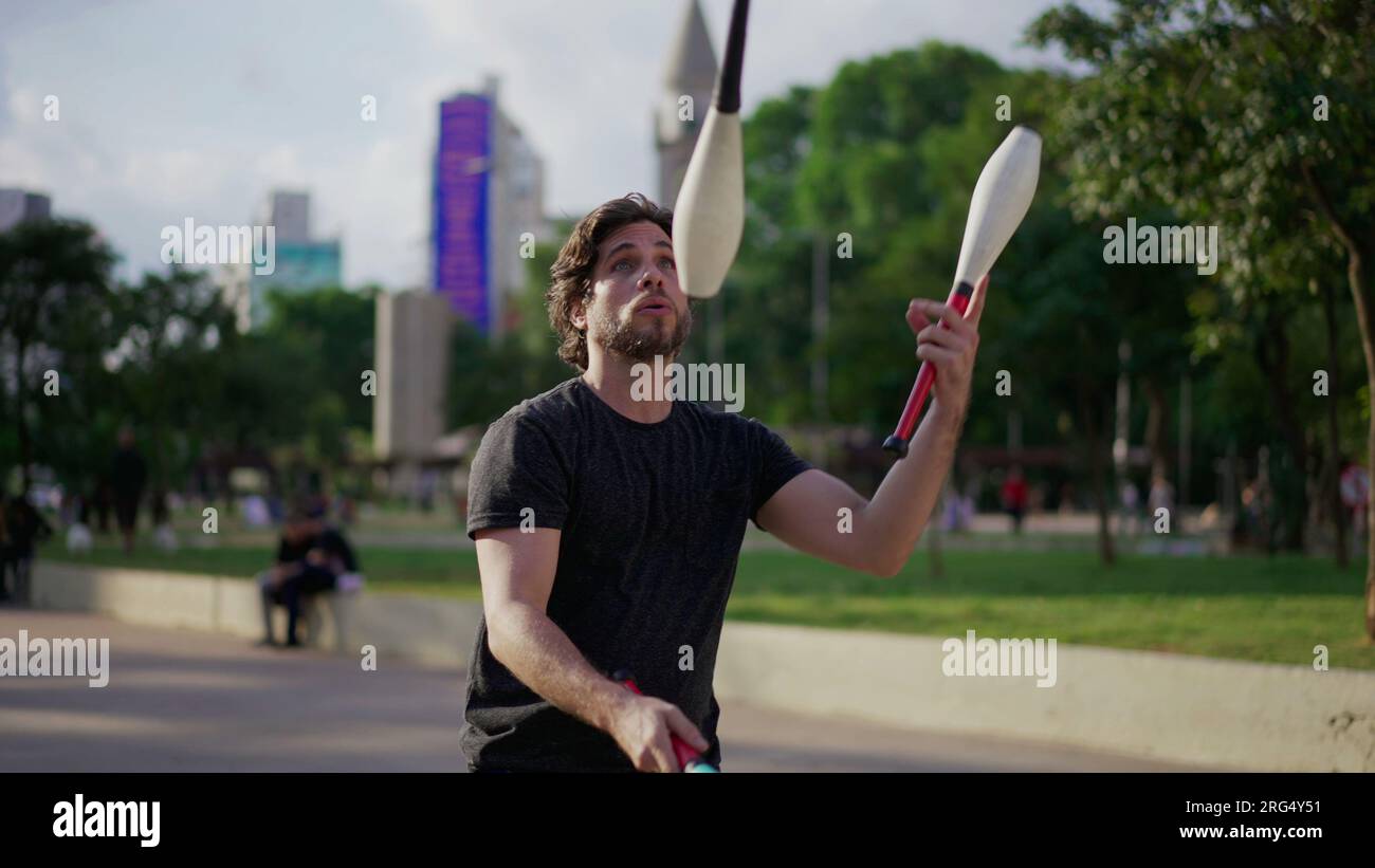 Male Juggler performer demonstrating his skills outside in urban city ...