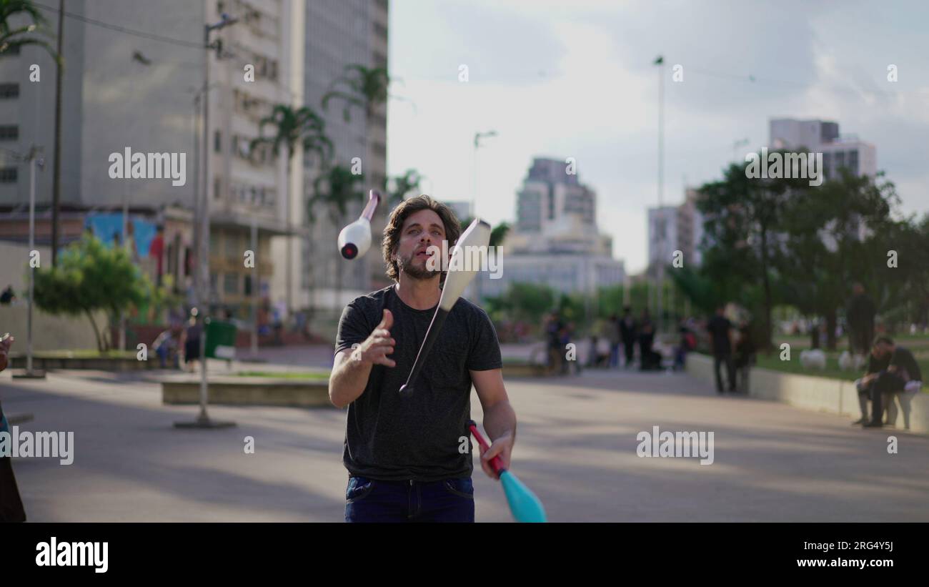 Male Juggler performer demonstrating his skills outside in urban city ...