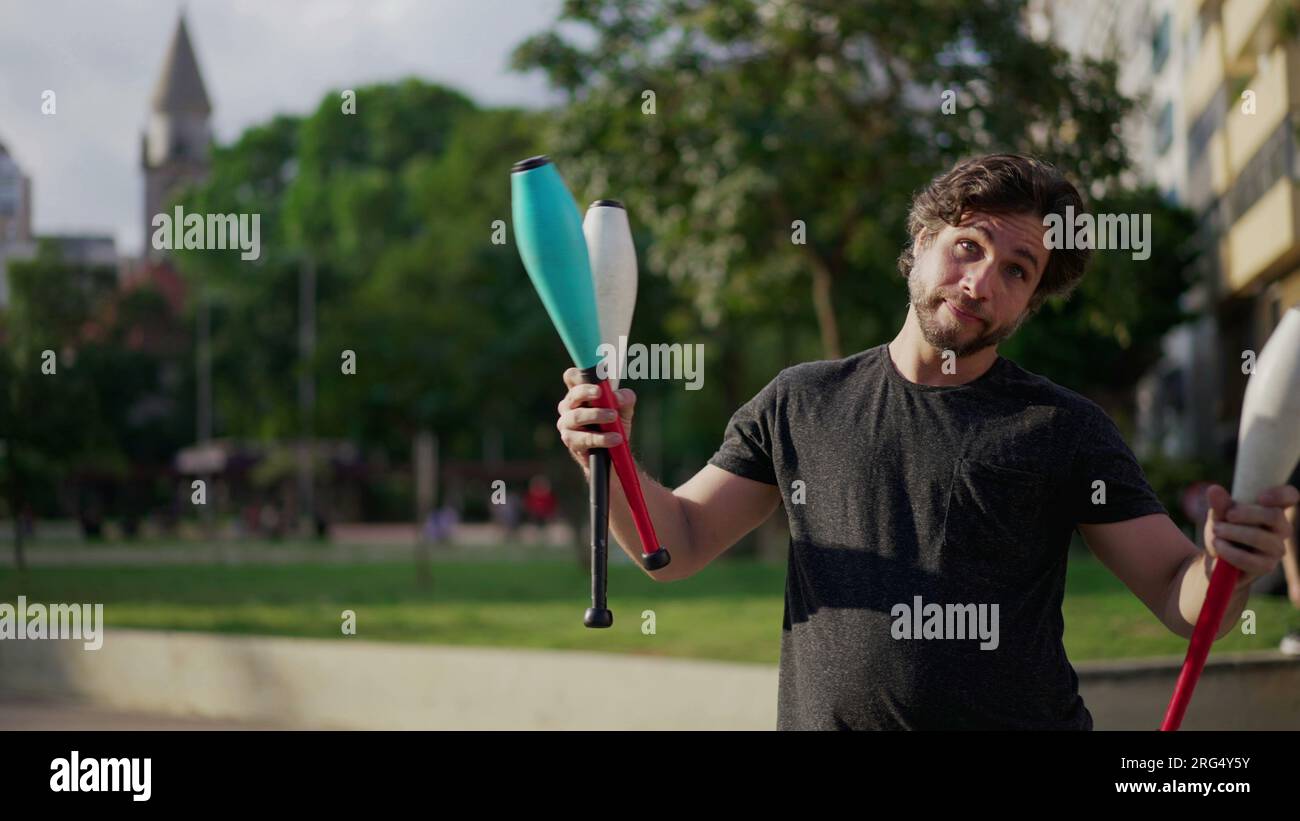 Male Juggler performer demonstrating his skills outside in urban city ...