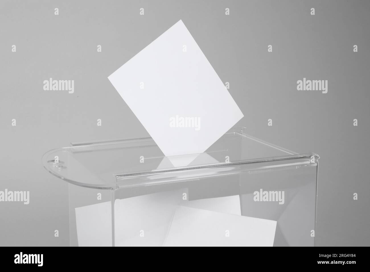 Ballot box with votes on light grey background. Election time Stock ...