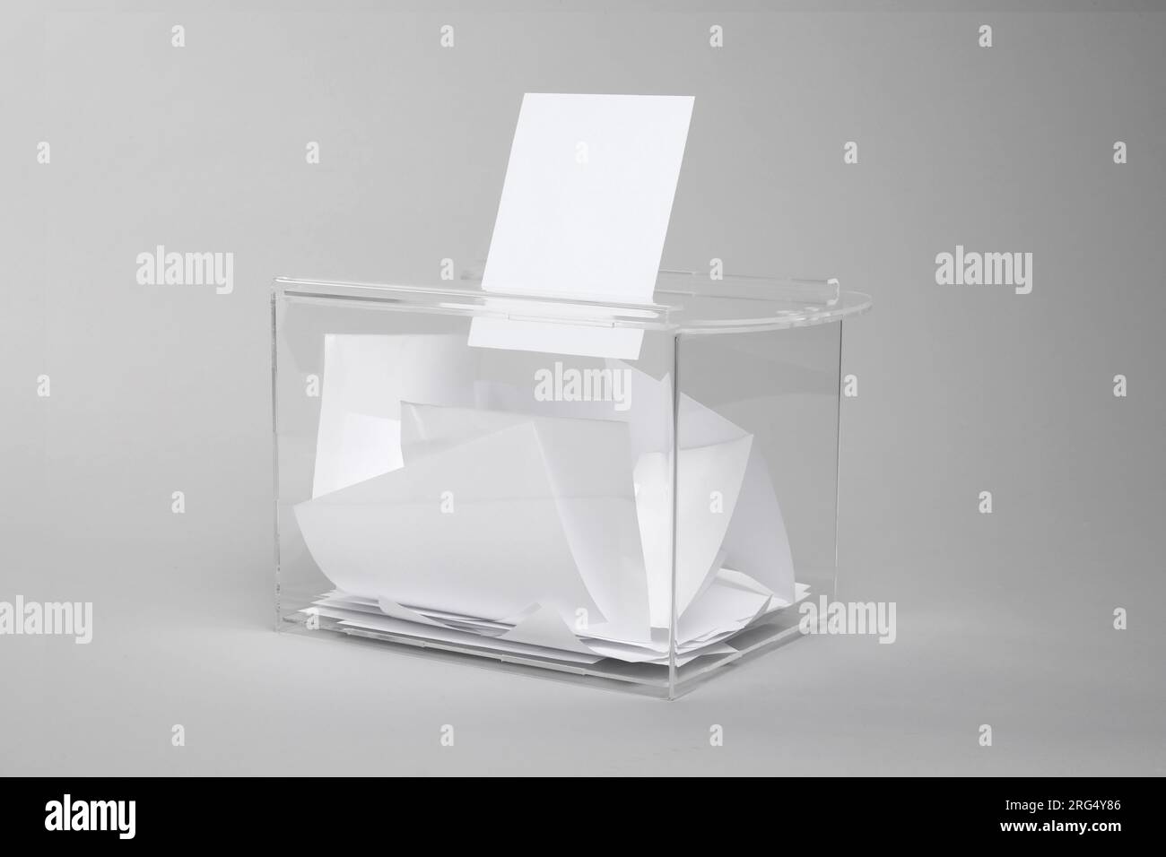 Ballot box with votes on light grey background. Election time Stock ...