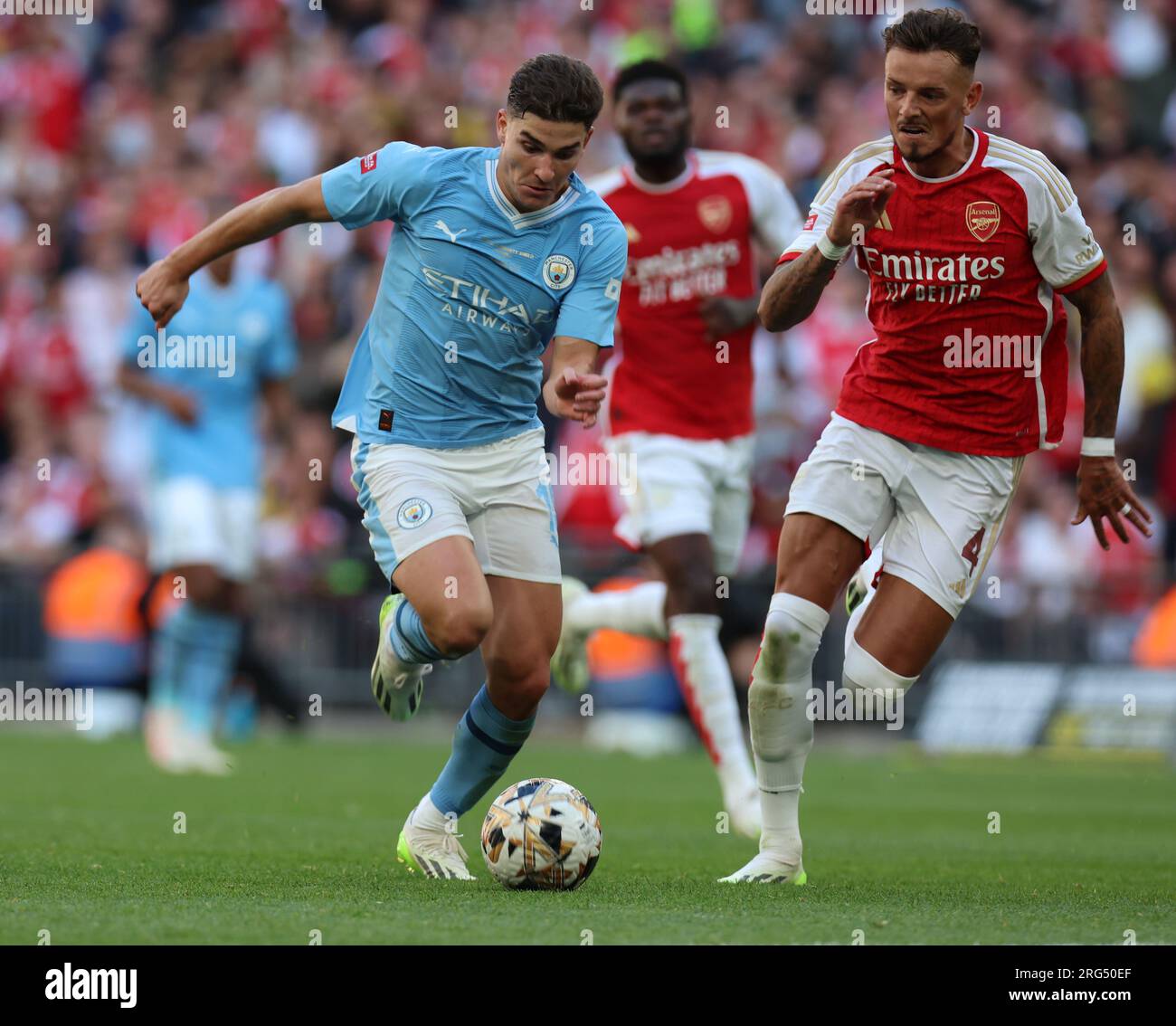 Manchester City's Julian Alvarez holds of Benjamin(Ben)White of Arsenal ...