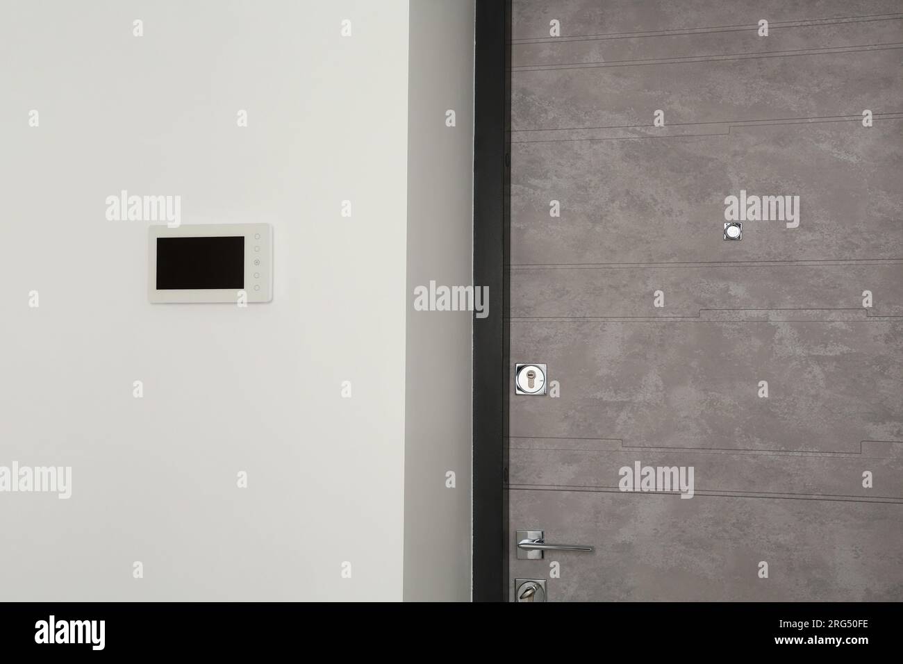 Modern video intercom on white wall near door Stock Photo - Alamy