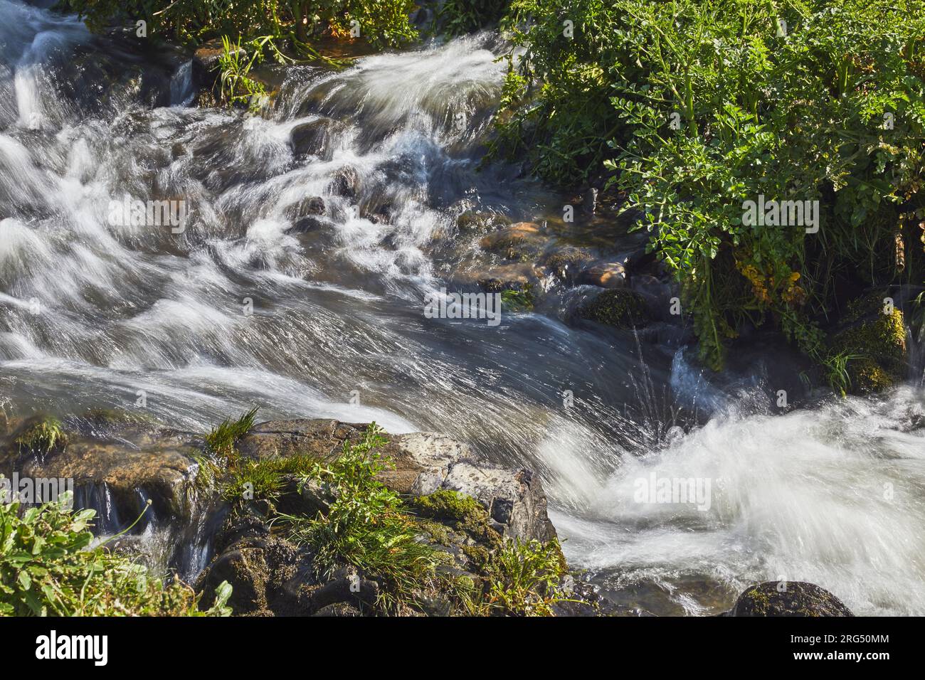 Water pouring over a waterfall in sunshine, at Welcombe Mouth, Hartland ...