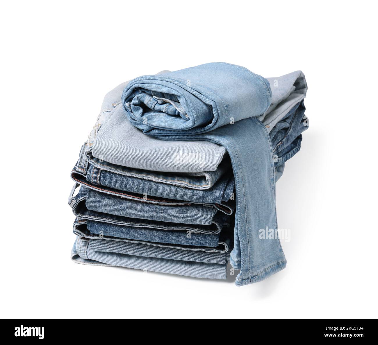Stack of different folded jeans isolated on white Stock Photo - Alamy