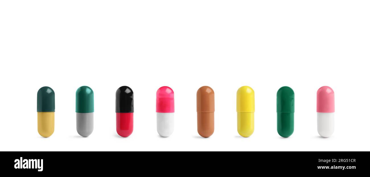 Set of different color pills in row isolated on white Stock Photo - Alamy