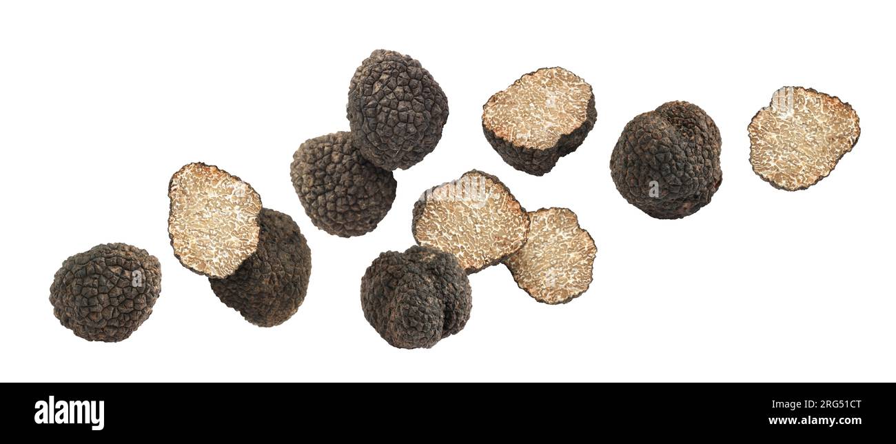 Cut and whole truffles falling on white background Stock Photo - Alamy