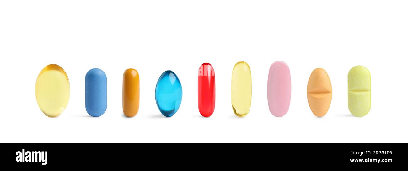 Set of different color pills in row isolated on white Stock Photo - Alamy