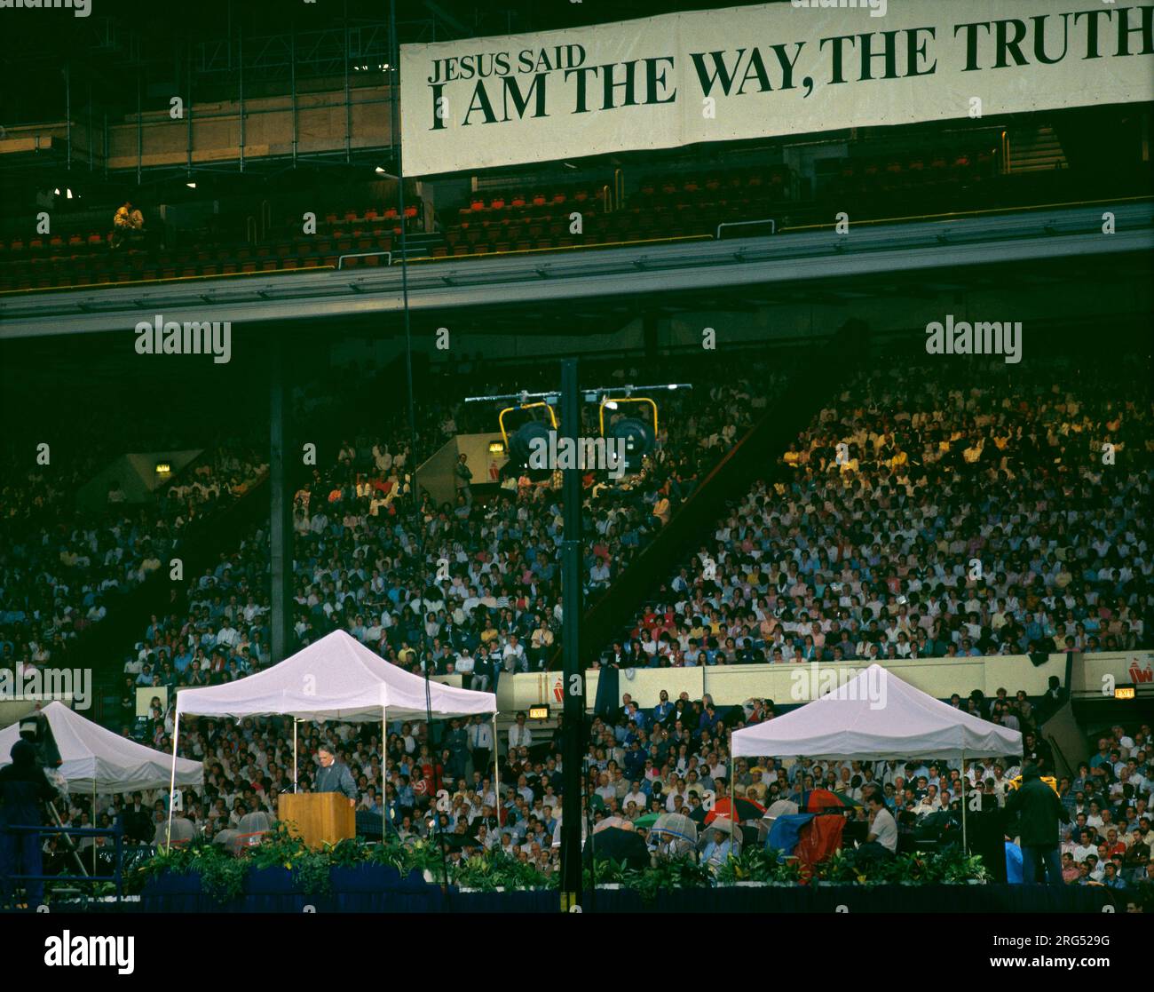 Billy Graham preaching at Wembley Stadium in the pouring rain, 8 July ...