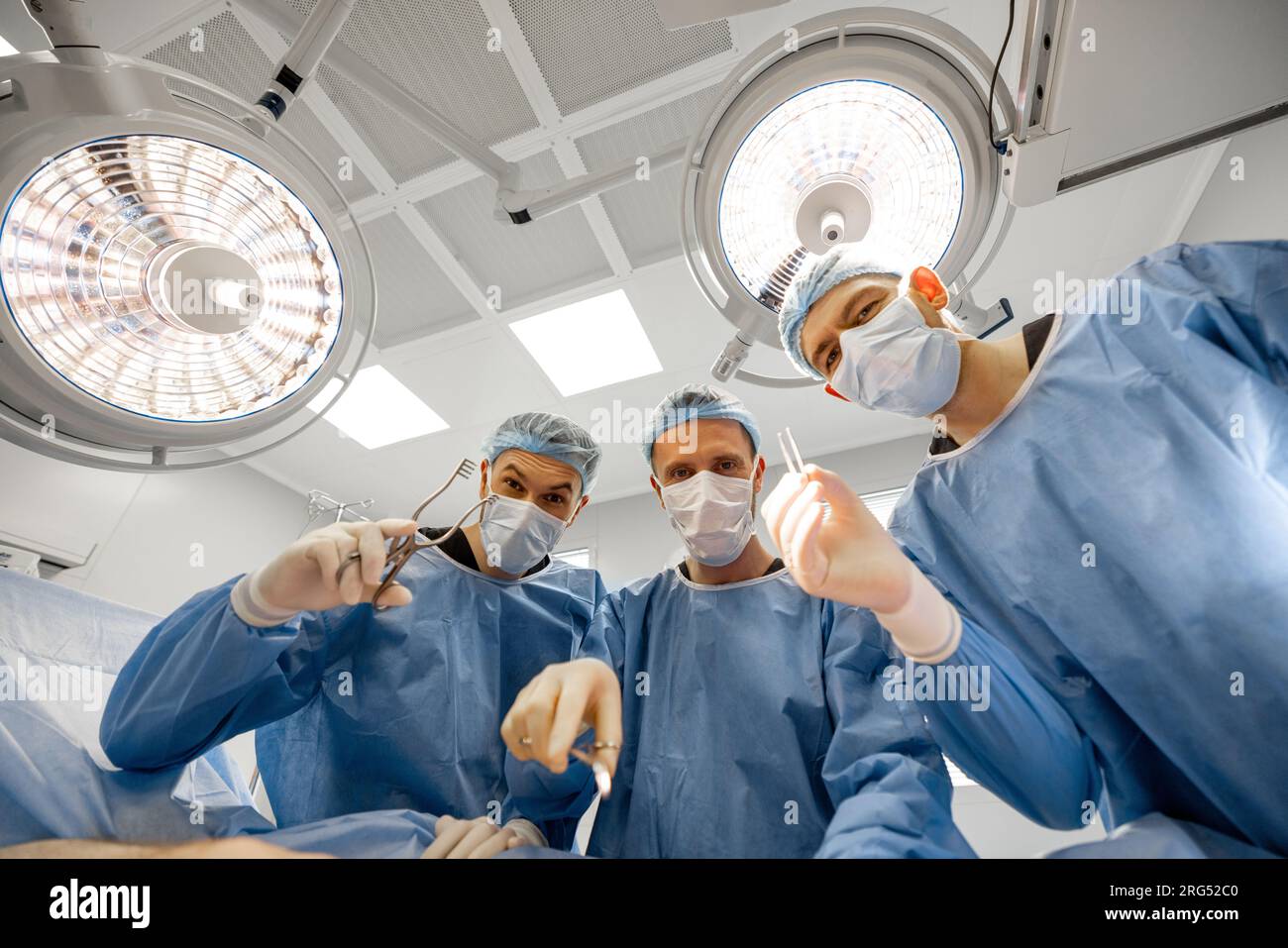 Portrait of three scary surgeons in operating room Stock Photo - Alamy