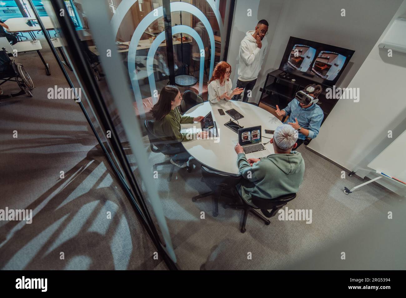 A diverse group of businessmen collaborates and tests a new virtual ...