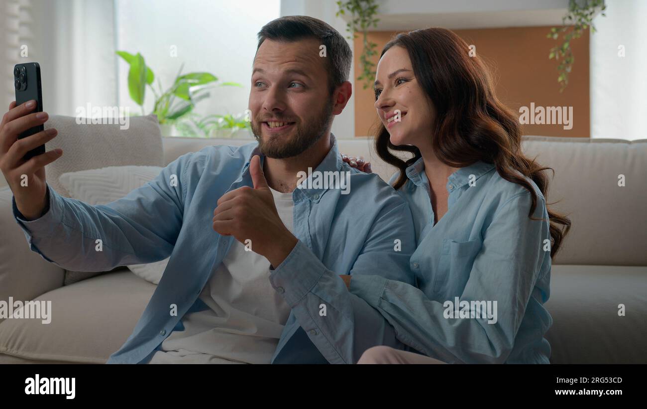 Caucasian happy couple family waving hello showing thumb up talking ...