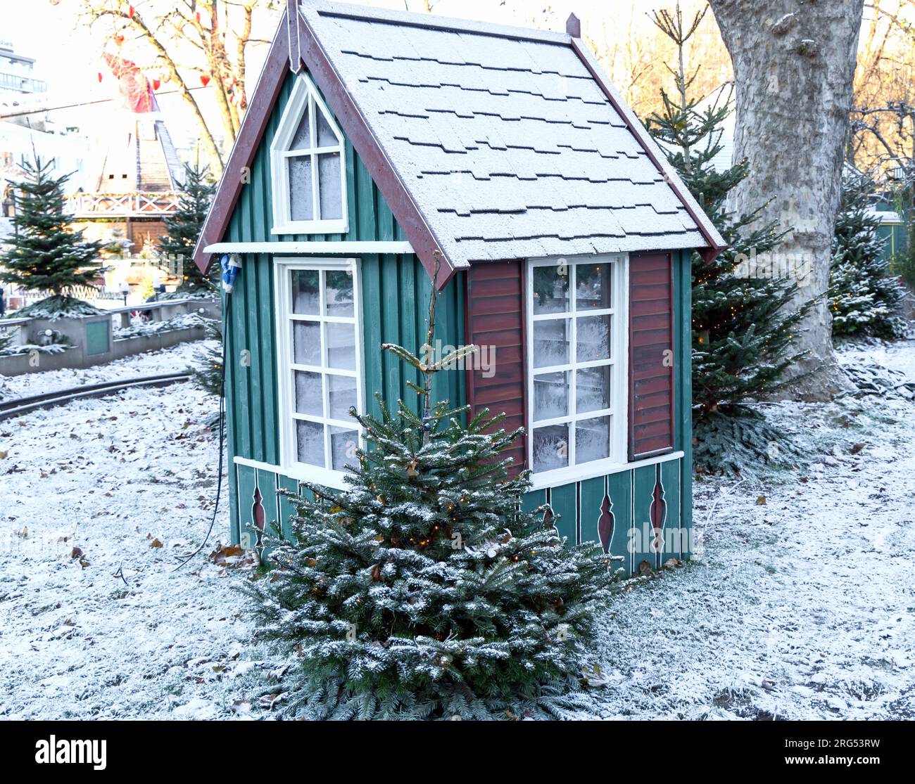 Small house with a fir tree on a winter snow day in Tivol - Copenhagen ...