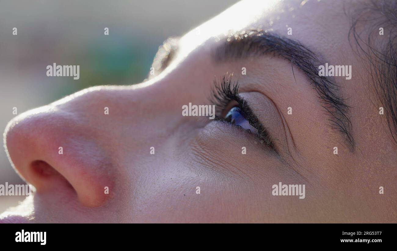 Woman opening eyes to sky feeling happy. Contemplative female person in ...