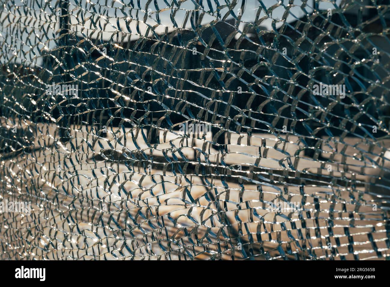 Abstract shot blurred summery city square through cracked broken glass ...
