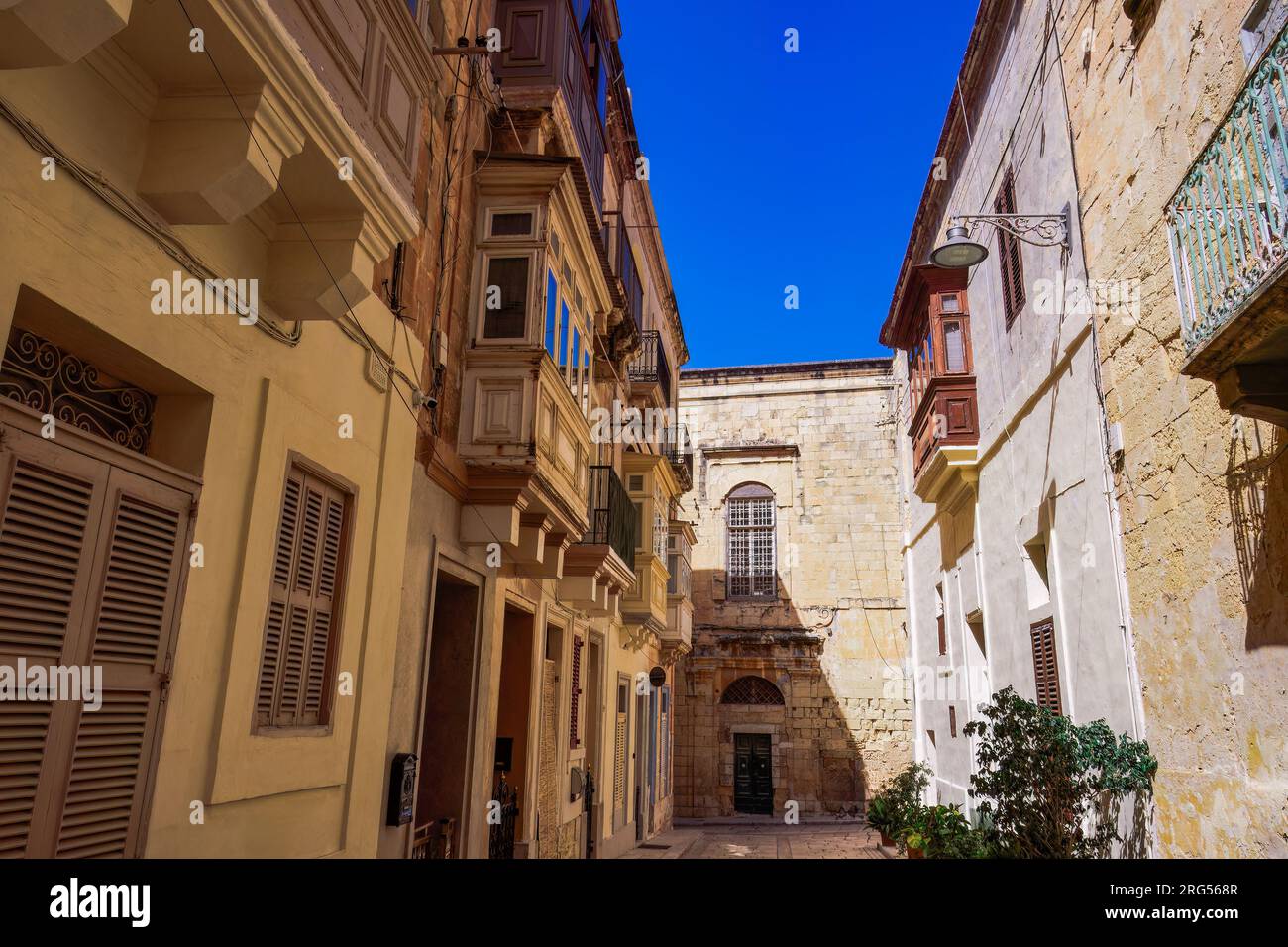 Traditional Maltese limestone buildings with coloured balconies in the ...