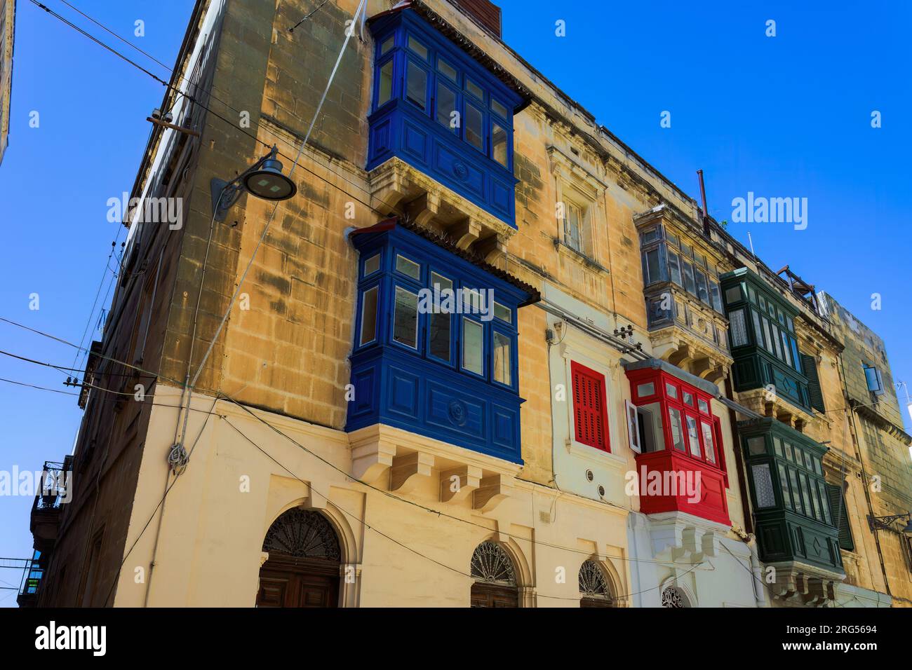 Traditional Maltese limestone buildings with coloured balconies in the ...