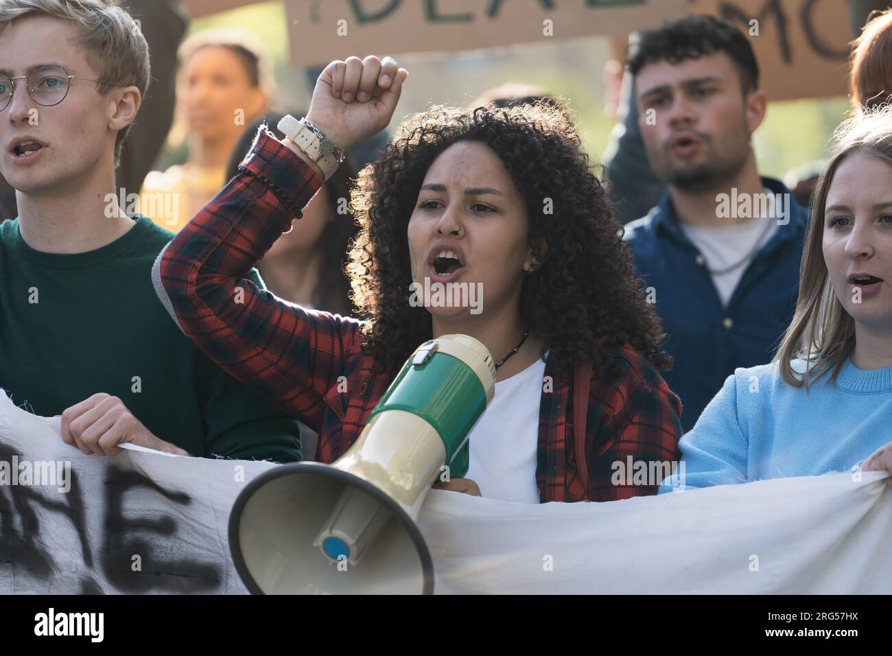Woman shouting megaphone raised fist hi-res stock photography and ...