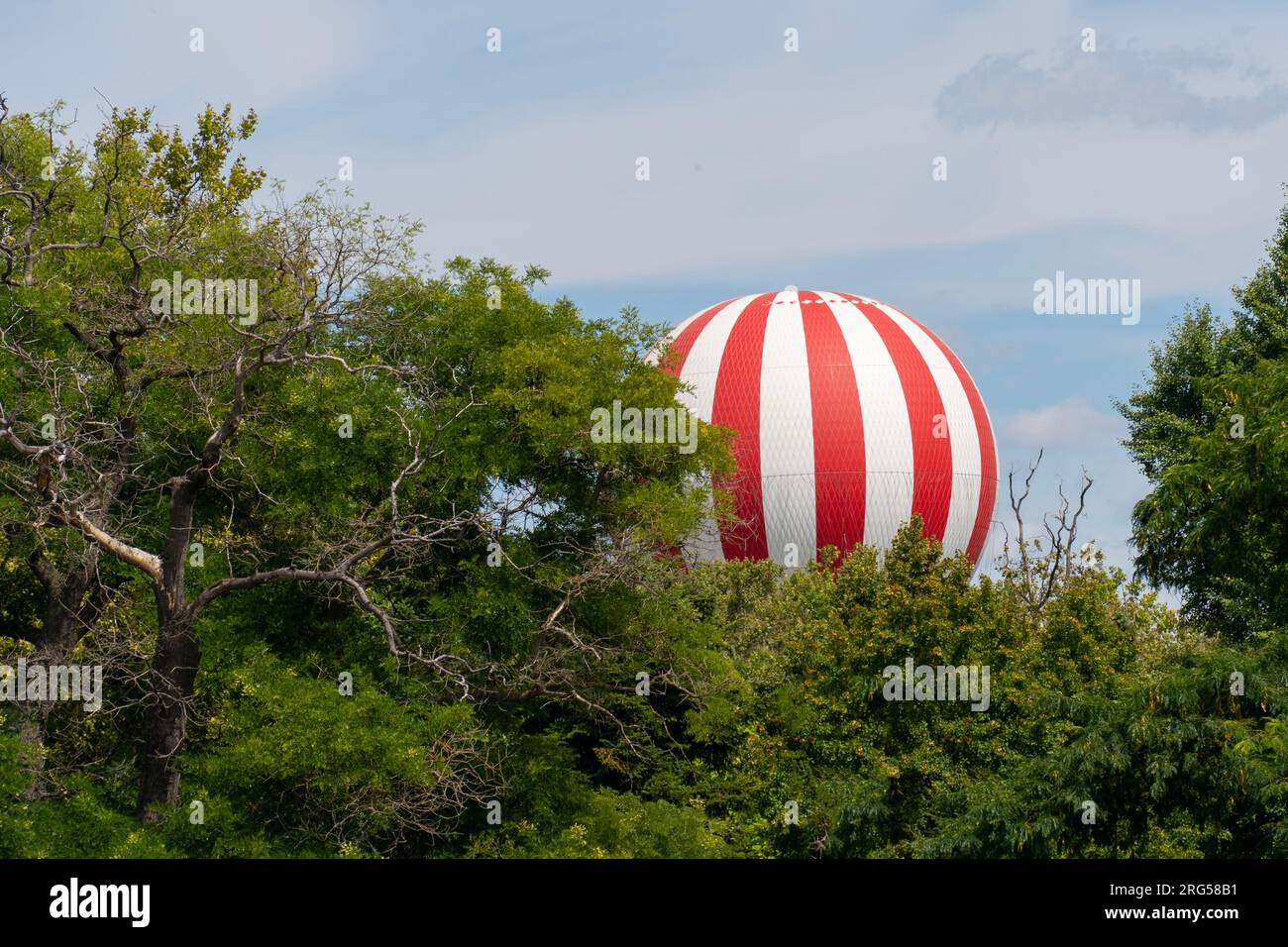Red and white balloon flying behind trees in Budapest, Hungary Stock ...