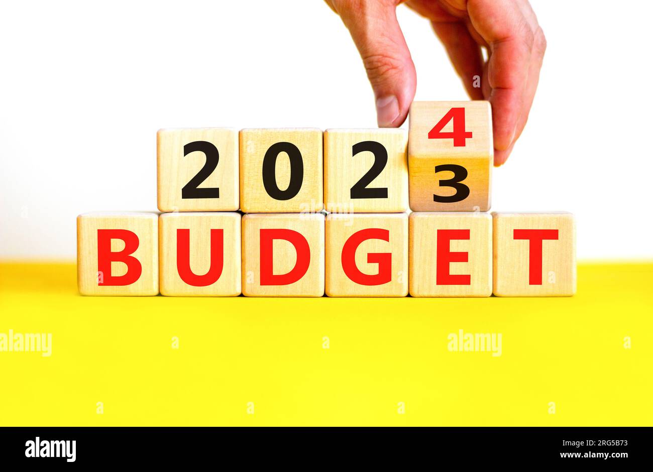 Planning 2024 budget new year symbol. Businessman turns a wooden cube ...