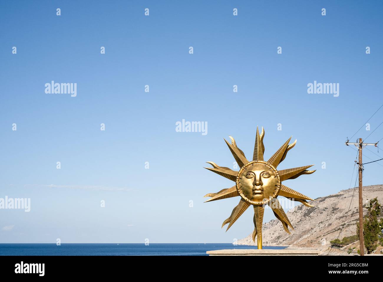 Apollo by Jeff Koons, Hydra, Greece, a large golden sun atop a small ...