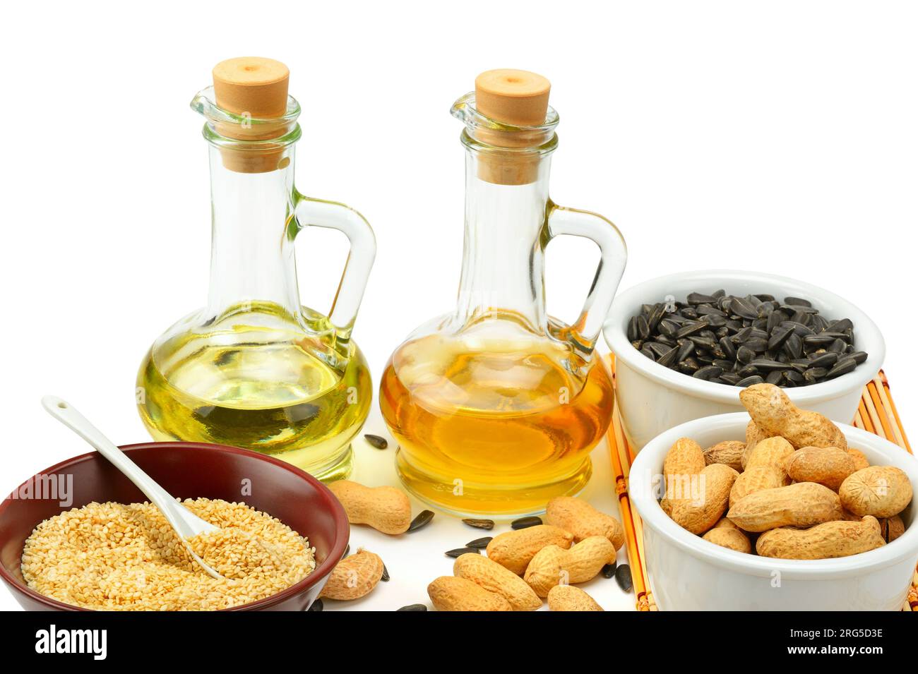 Sunflower seeds, peanuts and oil isolated on white Stock Photo - Alamy