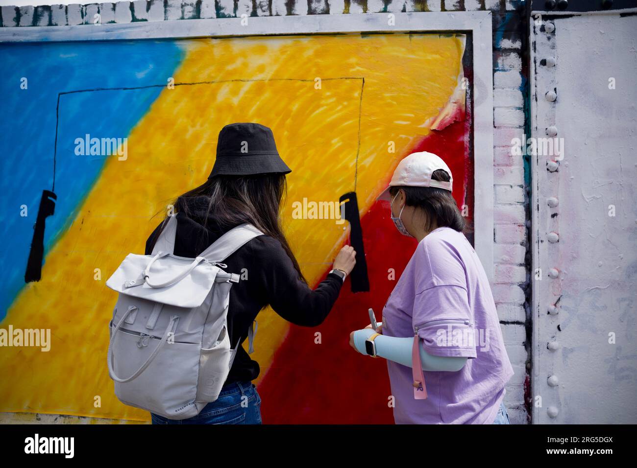 An anti-Chinese government activist is seen painting the wall at Brick ...
