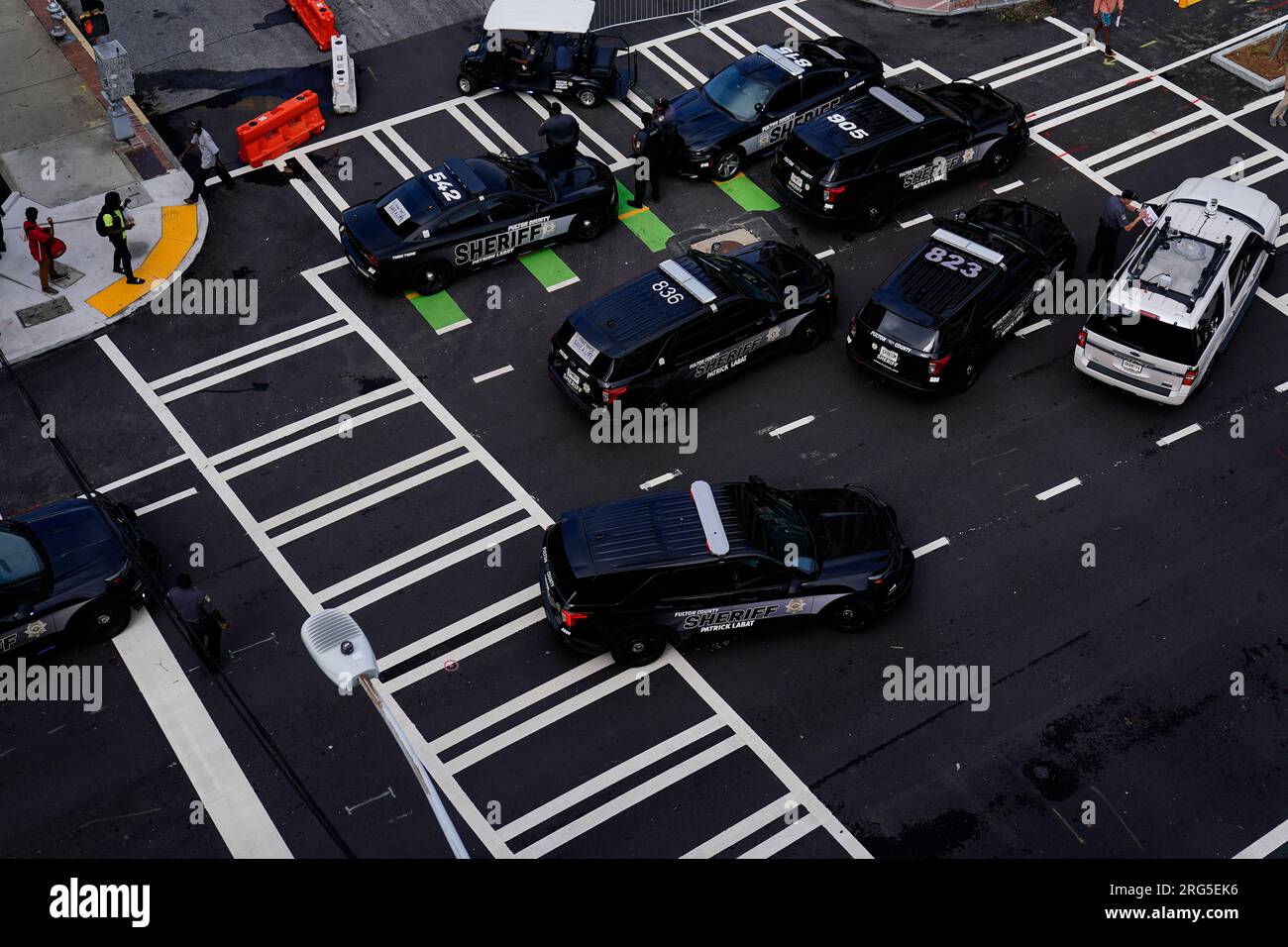Multiple vehicles are seen near barricades at the Fulton County ...