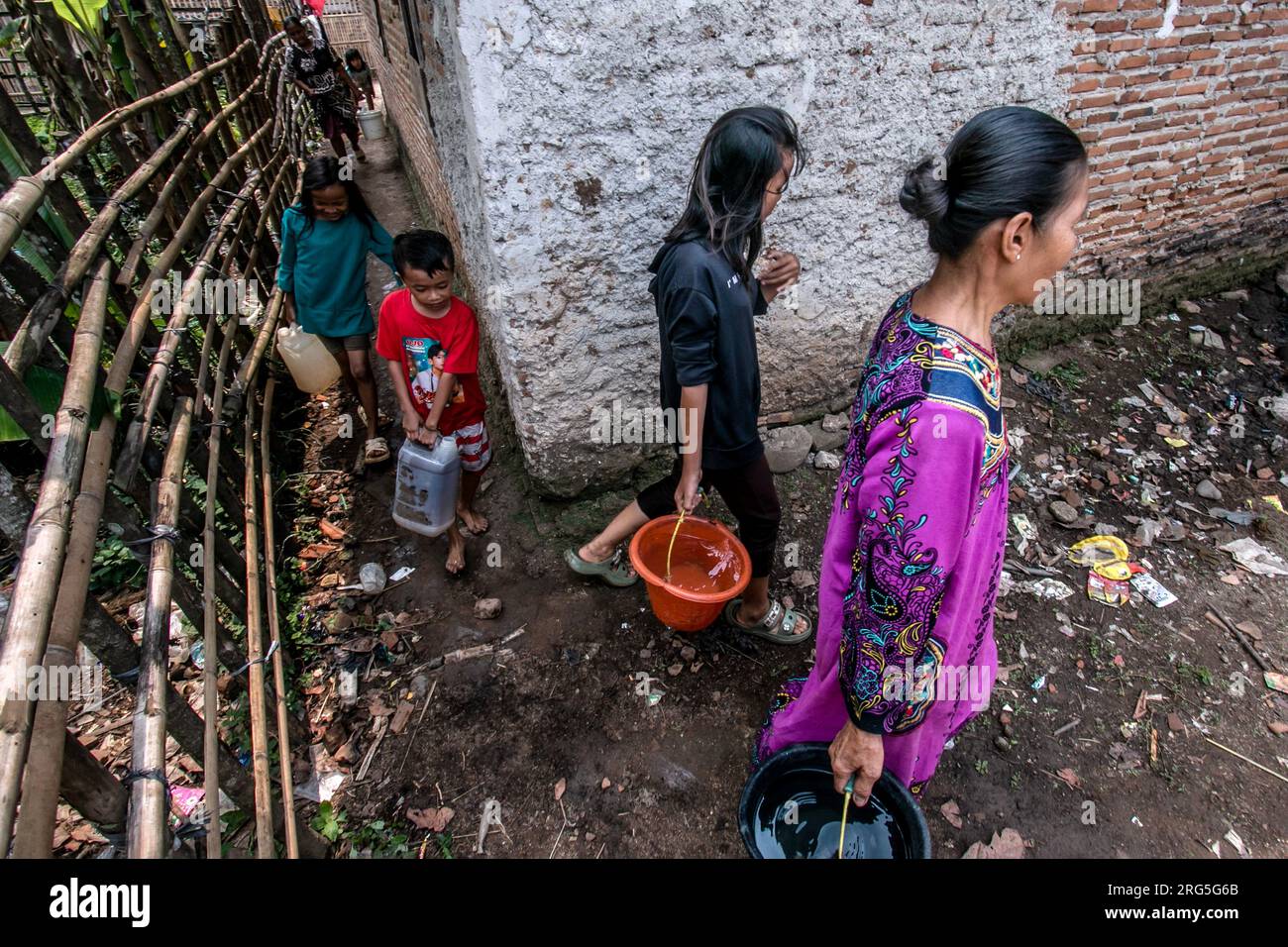 Local residents in Bogor, West Java, Indonesia, receive clean water ...
