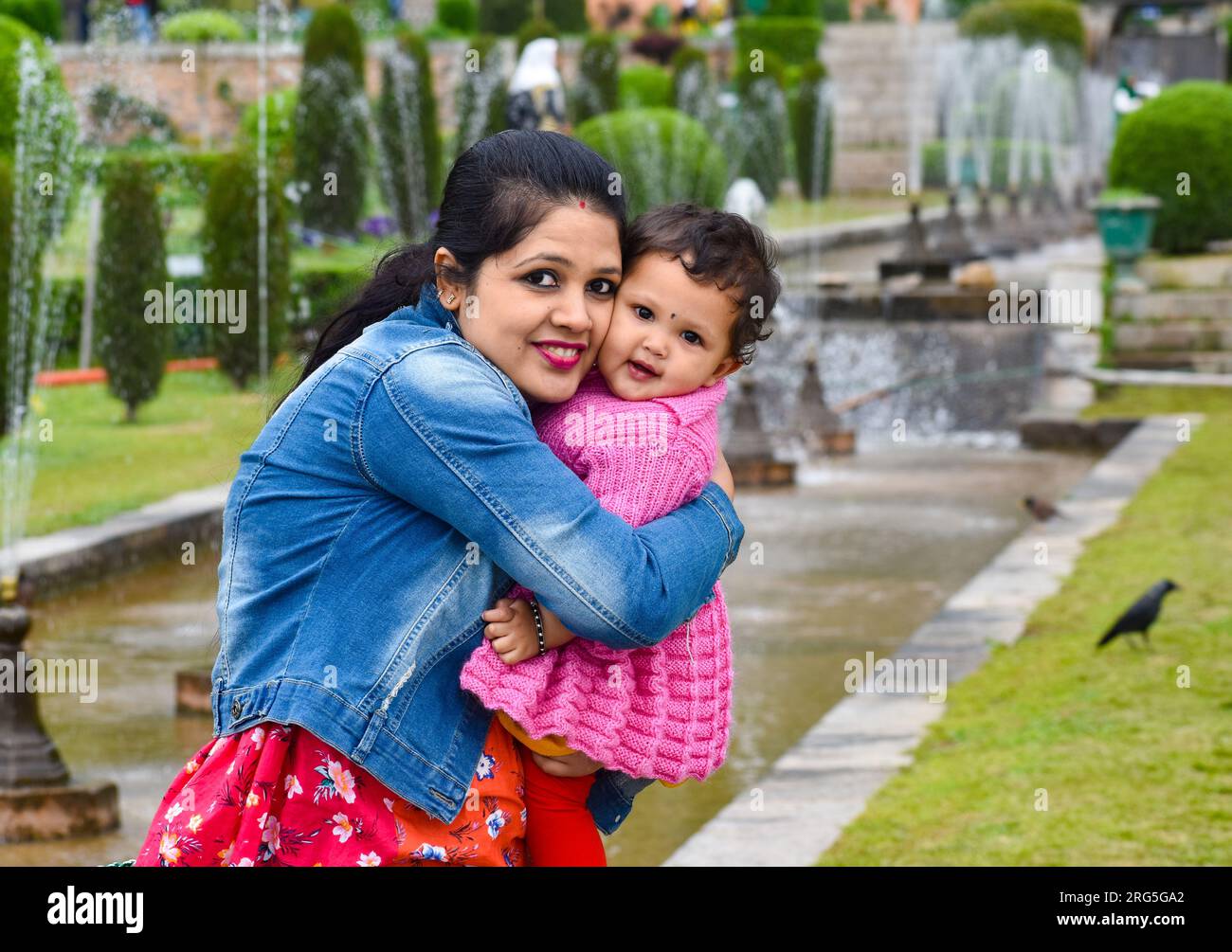 Mother and daughter or cute baby girl posing in Garden Stock Photo - Alamy