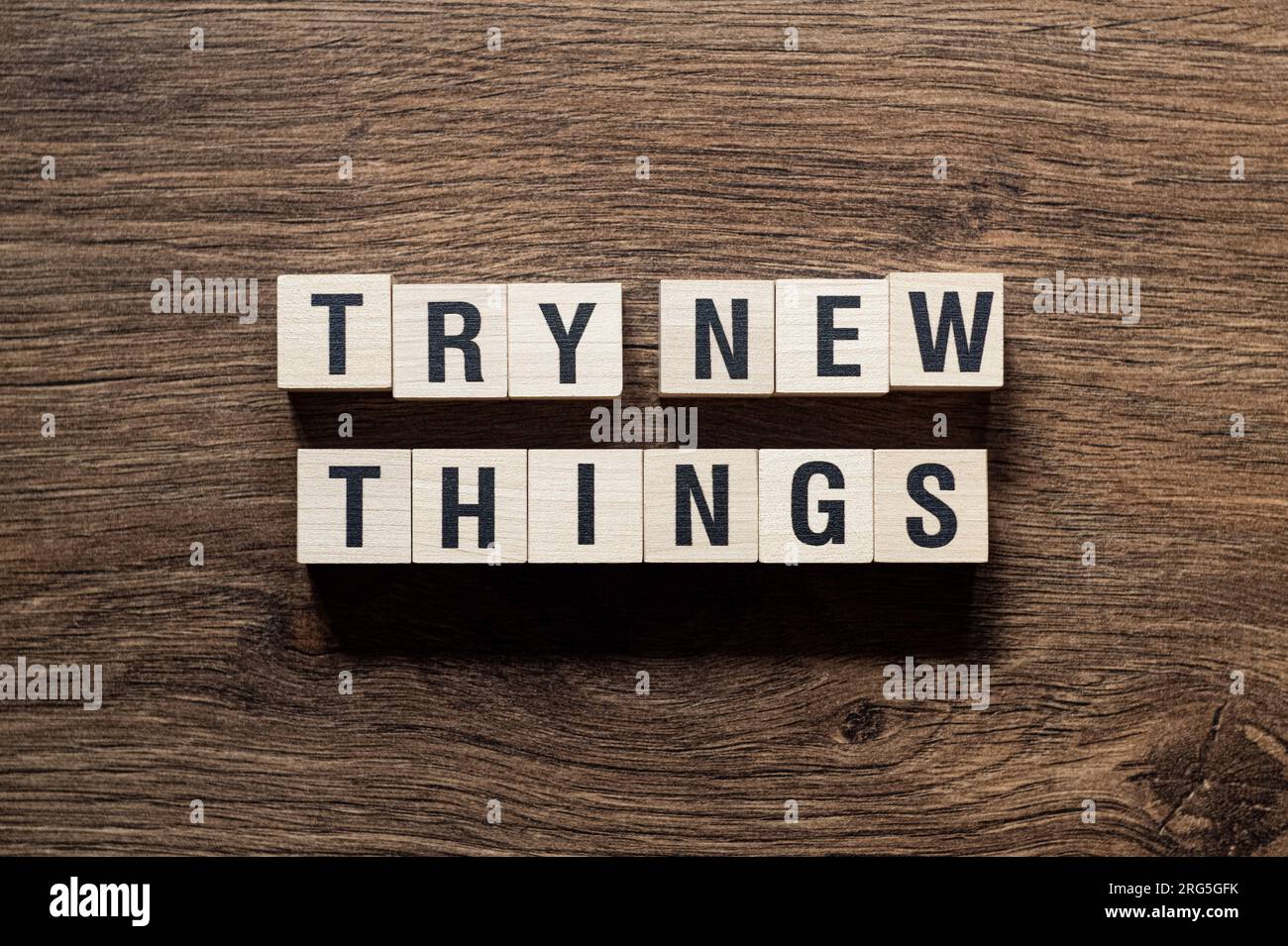 Try new things - word concept on building blocks, text Stock Photo - Alamy