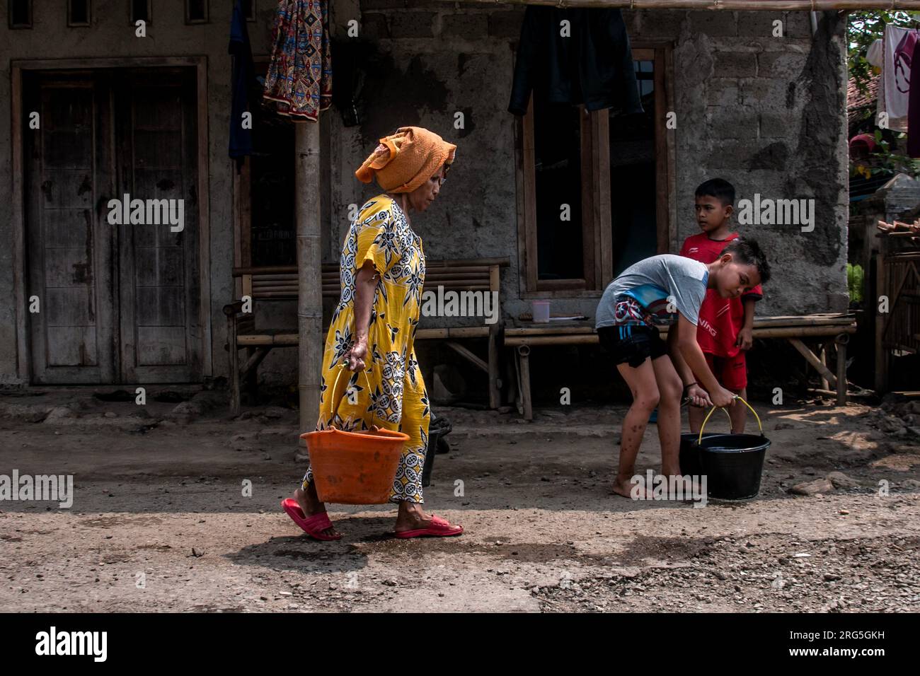 Local residents in Bogor, West Java, Indonesia, receive clean water ...