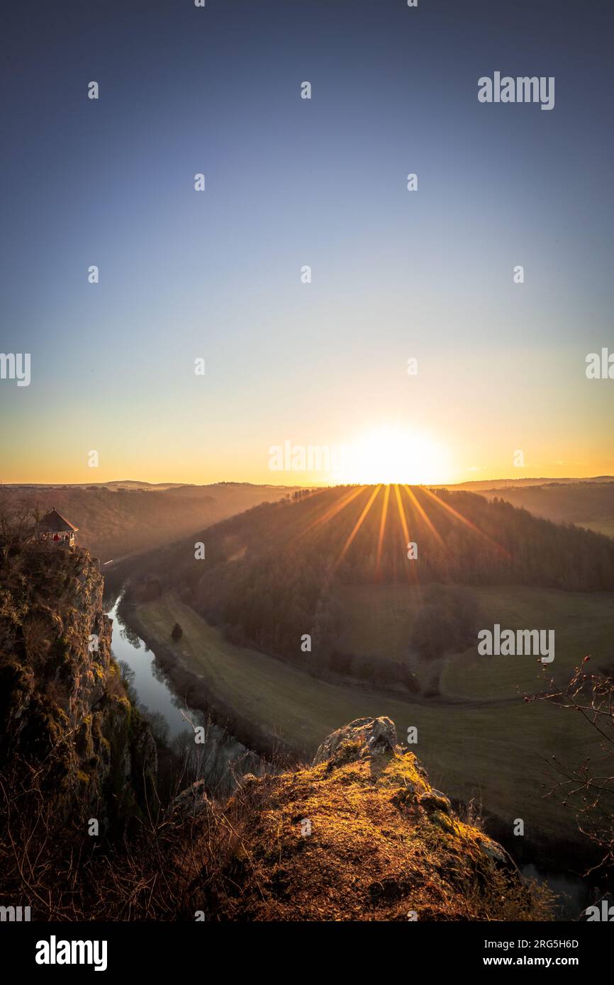 Backlit shot on a mountain with a view of the landscape, sunset, forest ...