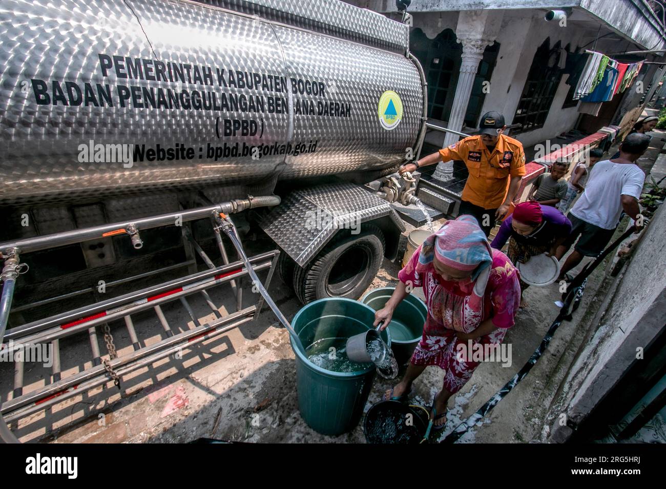 Local residents in Bogor, West Java, Indonesia, receive clean water ...